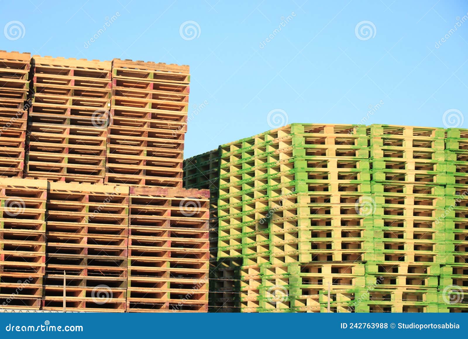Stacked wooden pallets stock photo. Image of pallets - 242763988