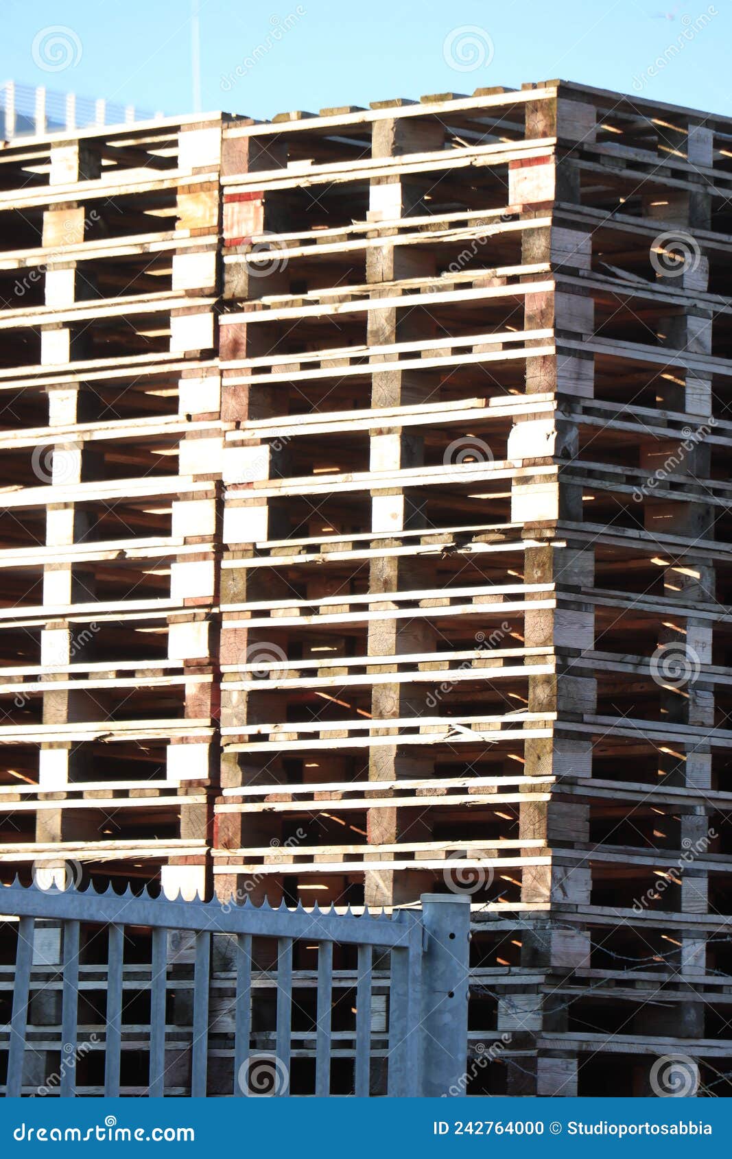 Stacked wooden pallets stock photo. Image of stacked - 242764000