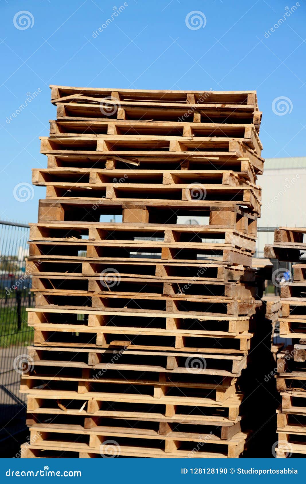 Stacked wooden pallets stock photo. Image of warehouse - 128128190