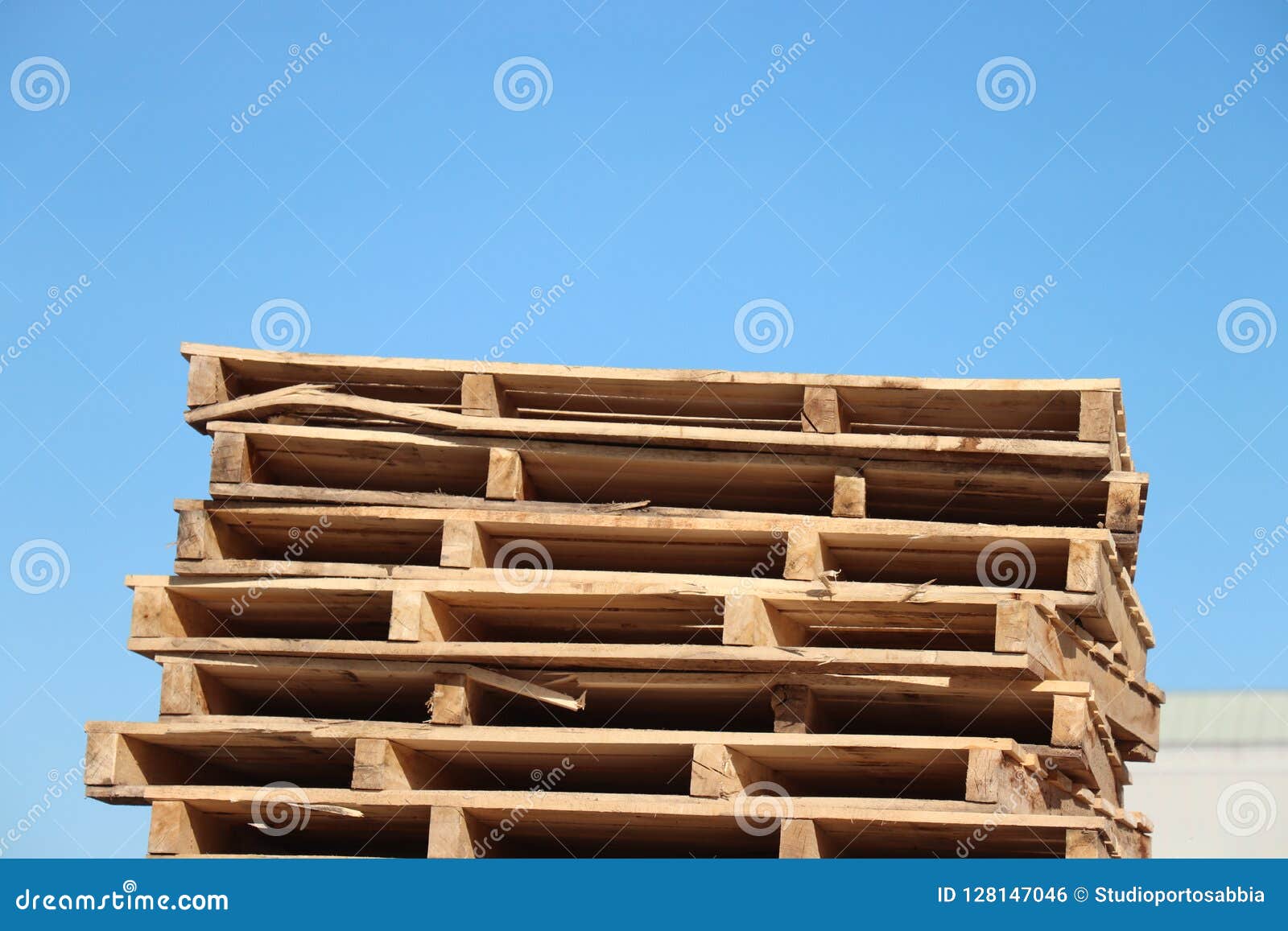Stacked wooden pallets stock photo. Image of shipping - 128147046