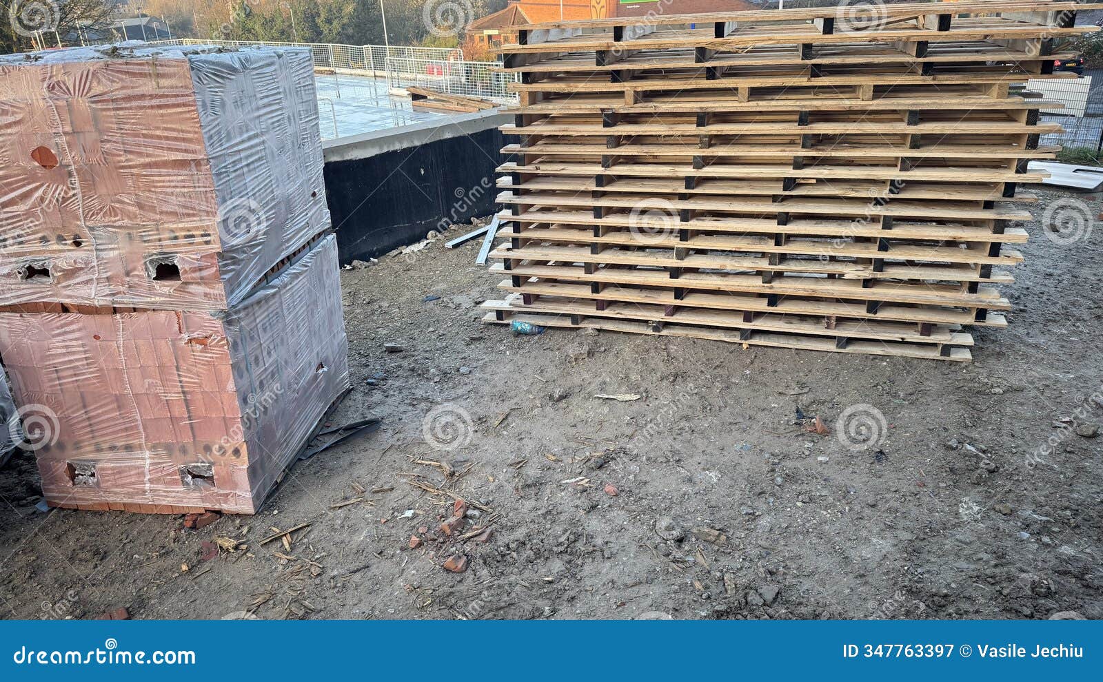 Stacked Wooden Pallets and Wrapped Bricks at Construction Site Stock ...