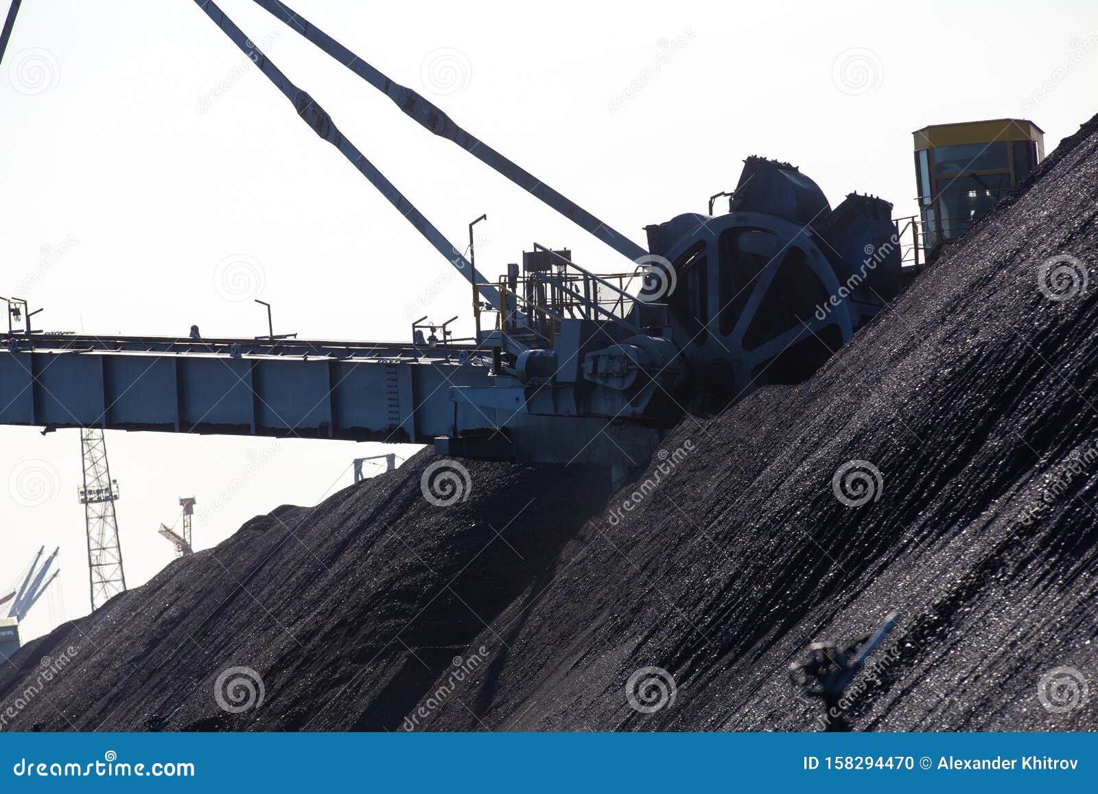 Stacker-reclaimer during Loading and Unloading of Coal. Coal Heaps at a ...