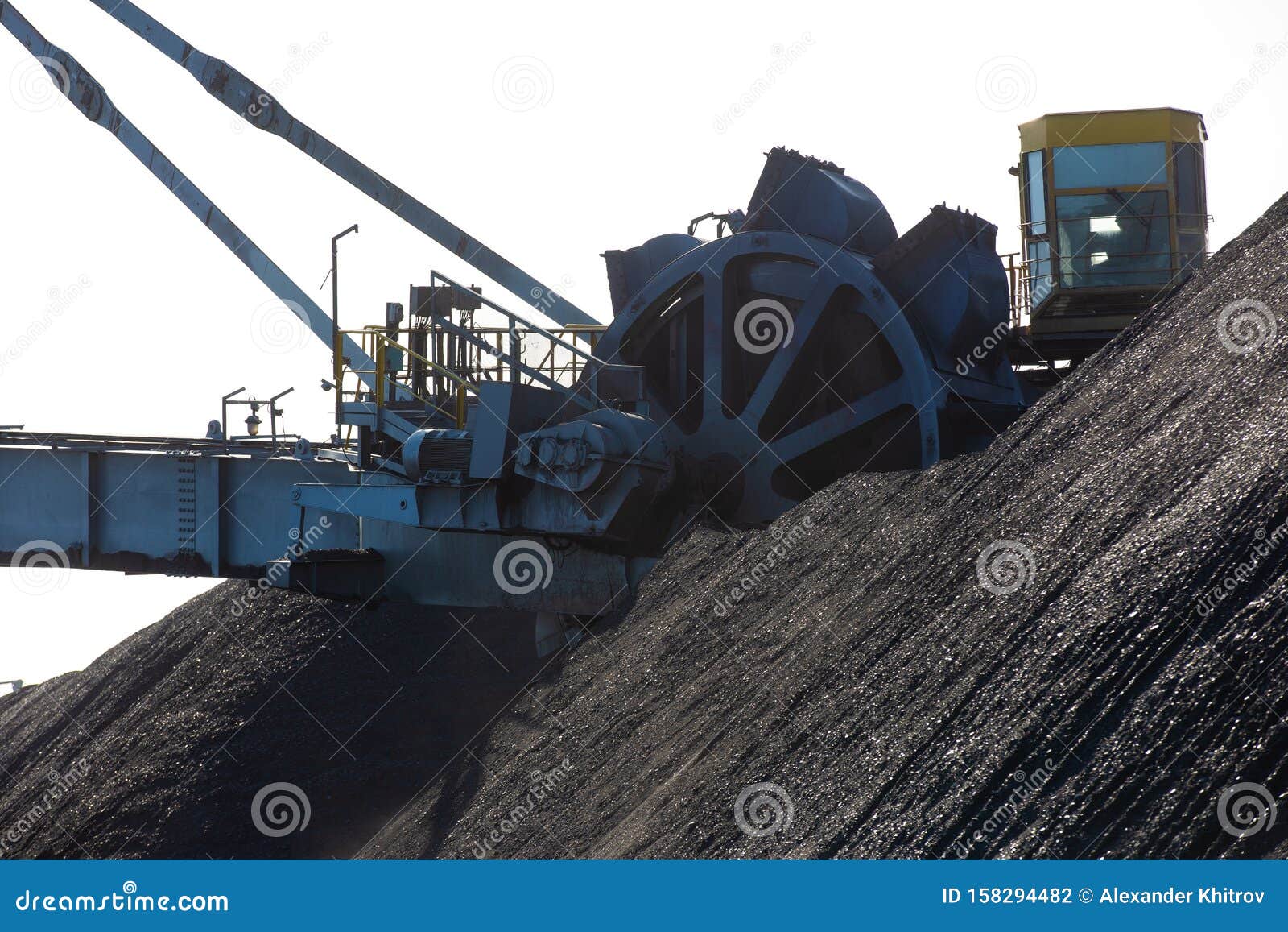 Stacker-reclaimer during Loading and Unloading of Coal. Coal Heaps at a ...