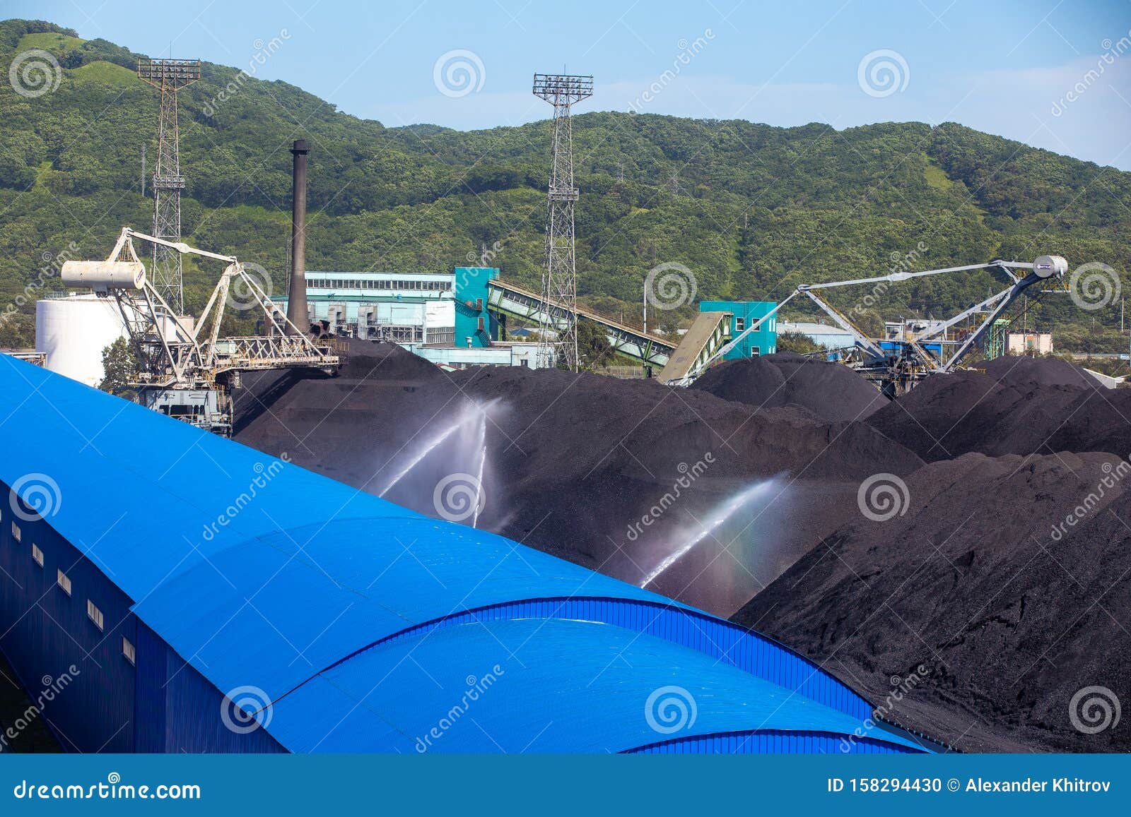 Stacker-reclaimer during Loading and Unloading of Coal. Coal Heaps at a ...
