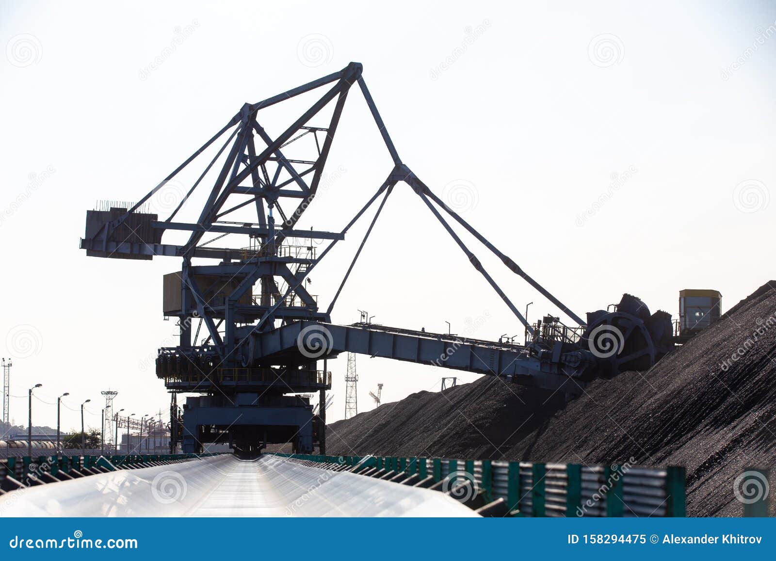 Stacker-reclaimer during Loading and Unloading of Coal. Coal Heaps at a ...