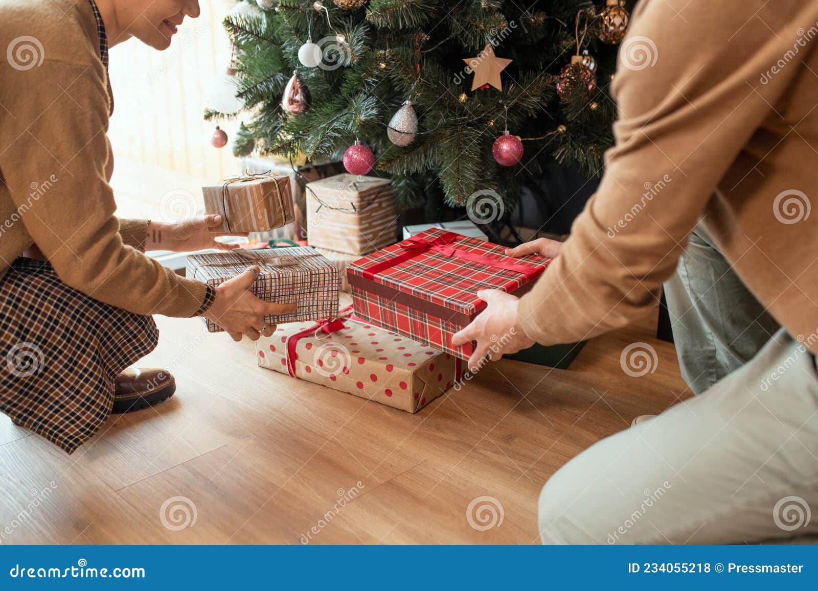 Stacking Christmas Presents Under Tree Stock Photo - Image of ...