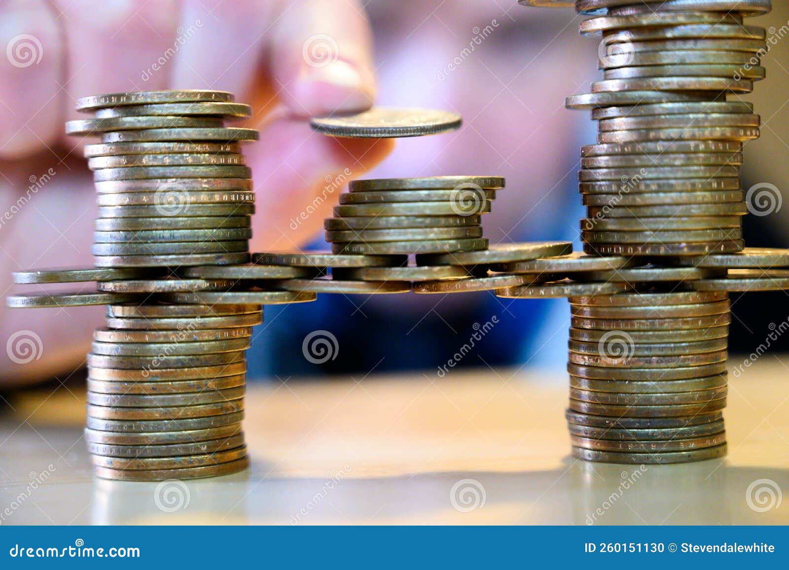 Stacking Gold Dollar Coins into Bridge Using a Cantilever Stock Photo ...