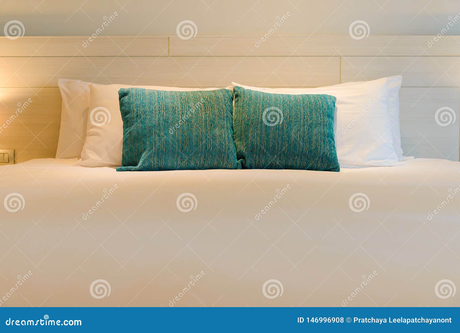 White Bed Sheets with Wooden Bedhead in Bedroom - Stacking of Pillows ...