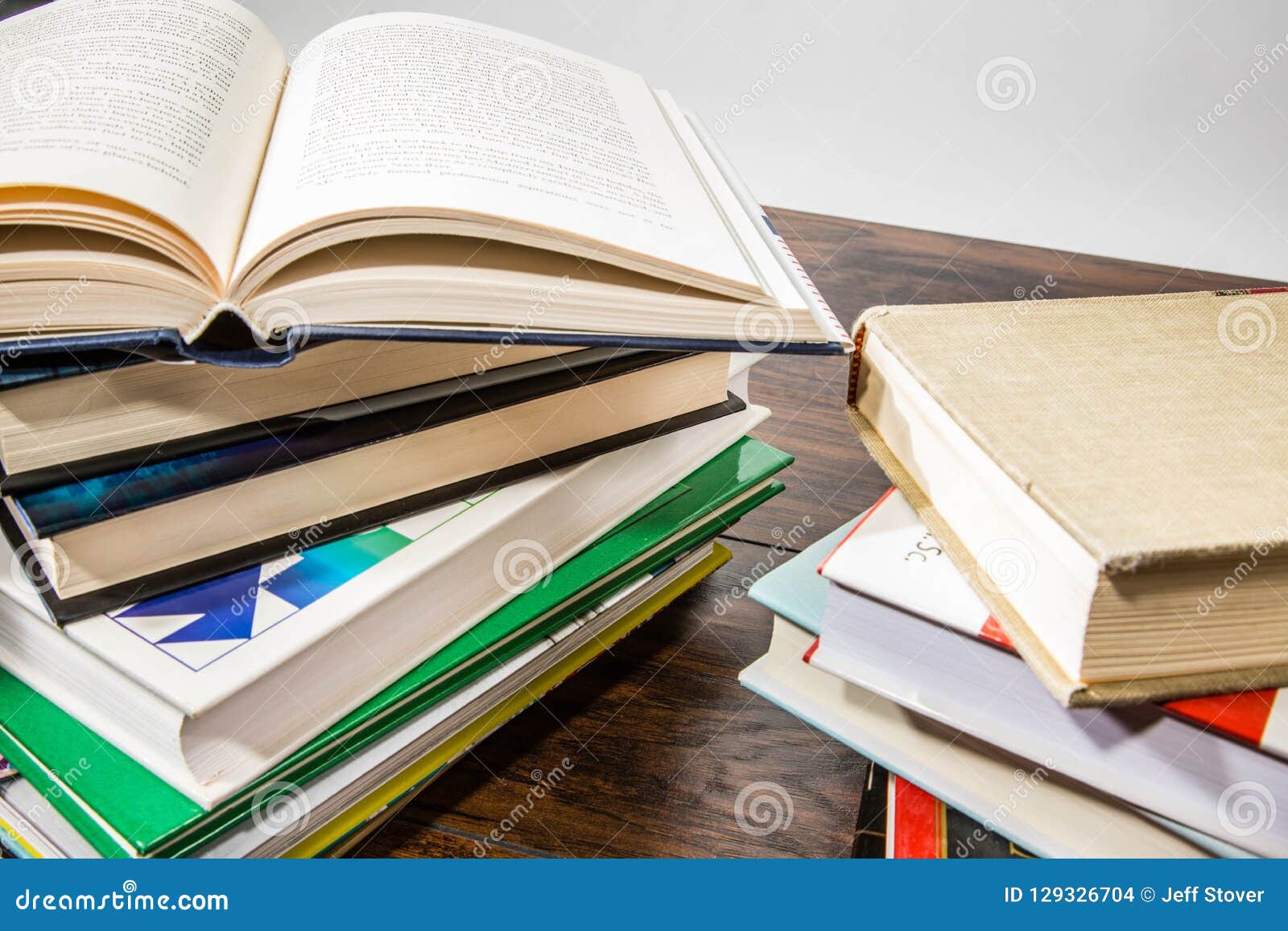 Stacks of Books with One Open on Top of Stack Stock Photo - Image of ...
