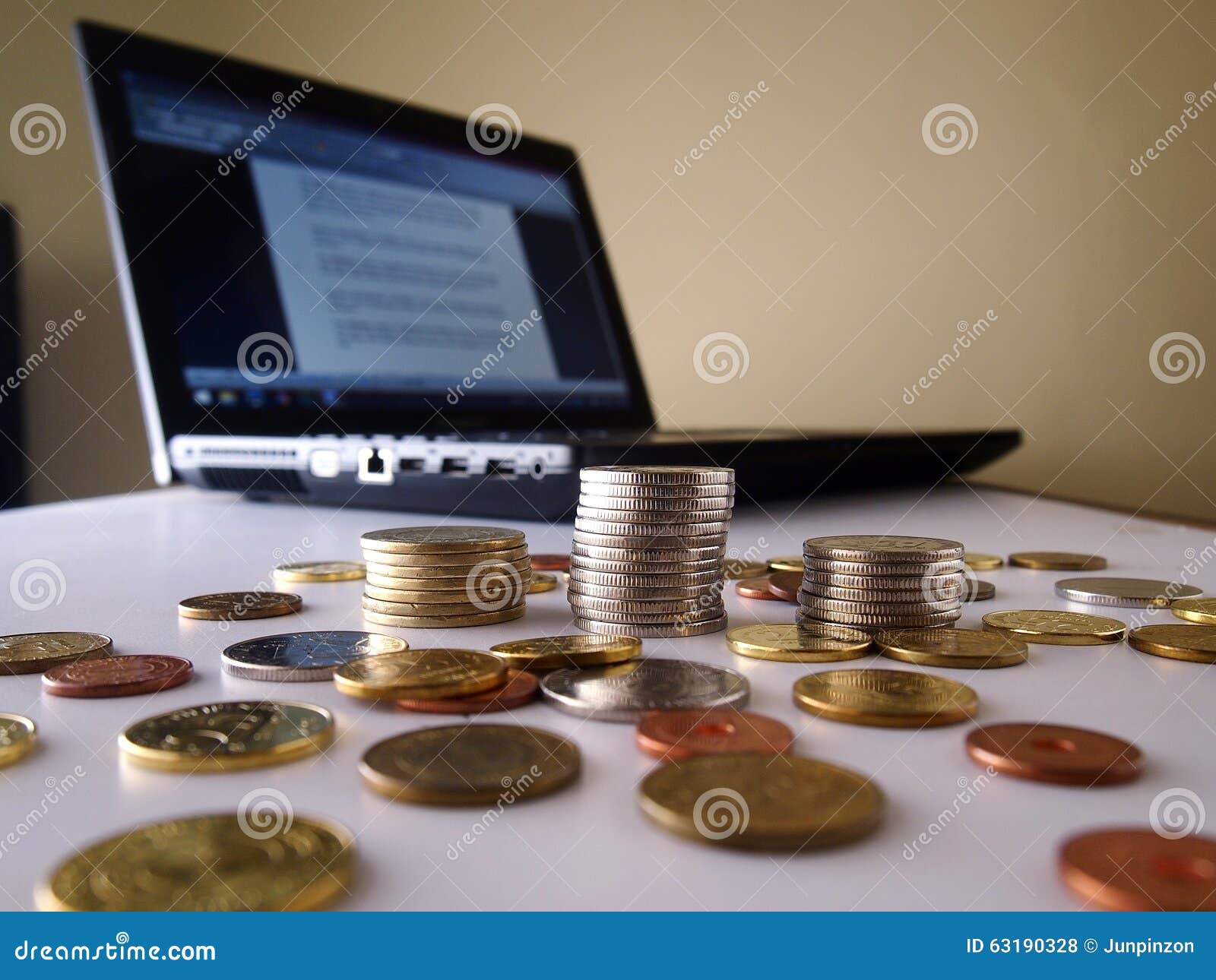 Stacks of Coins and a Laptop Computer Stock Photo - Image of banking ...