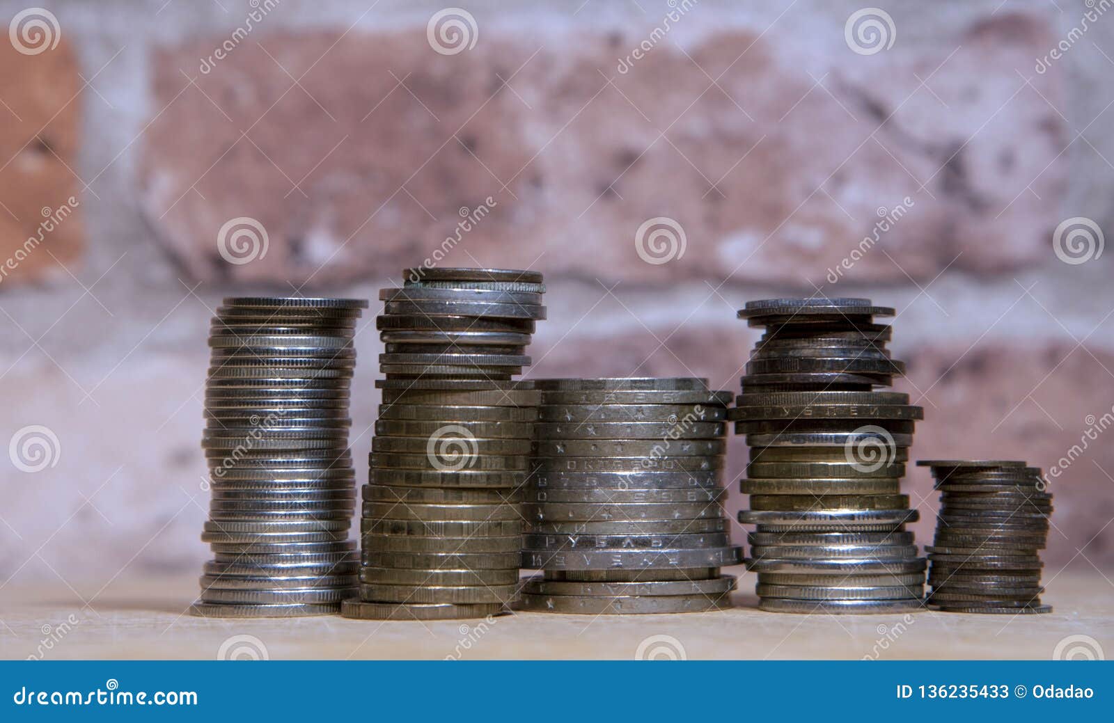 Stacks of Coins and a Vintage Brick Wall Stock Image - Image of ...