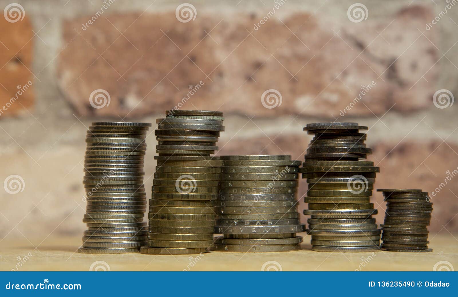 Stacks of Coins and a Vintage Brick Wall Stock Photo - Image of ...