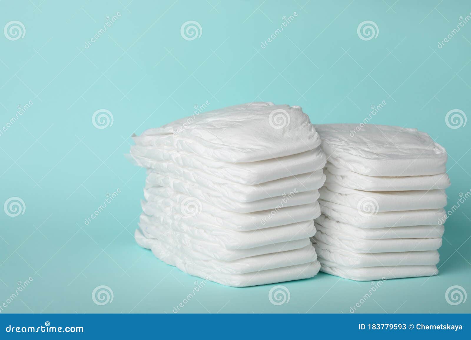 Stacks Of Diapers Stacked In Staggered Rows On A White Background ...
