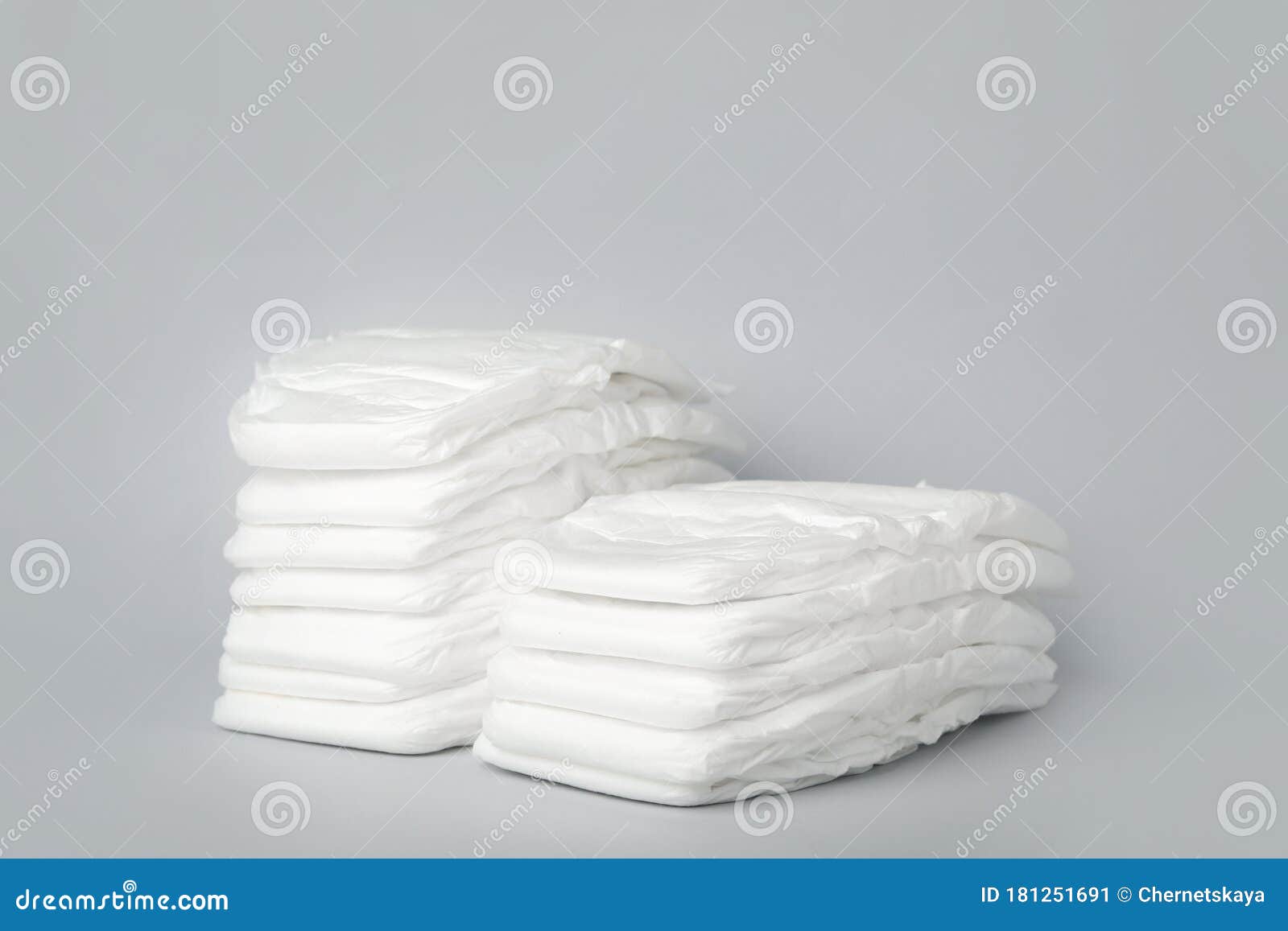 Stacks Of Diapers Stacked In Staggered Rows On A White Background ...