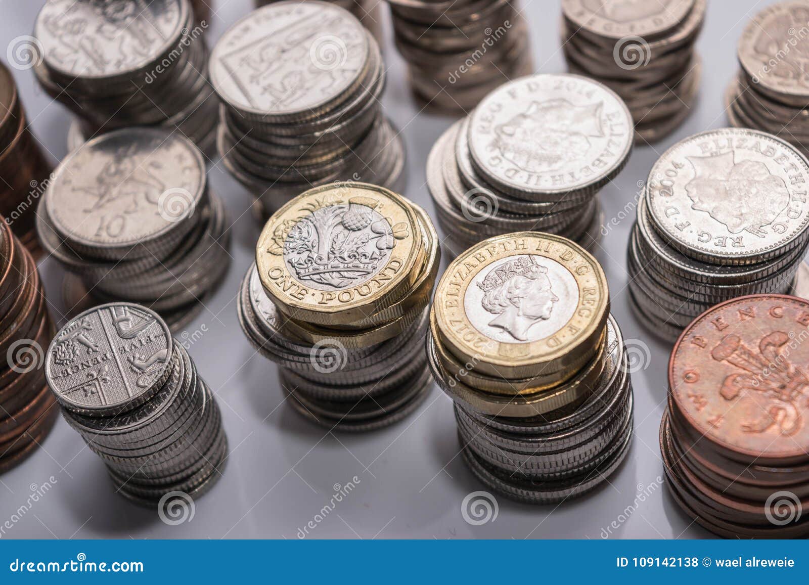Stacks of Different British Coins on a White Background. Editorial ...