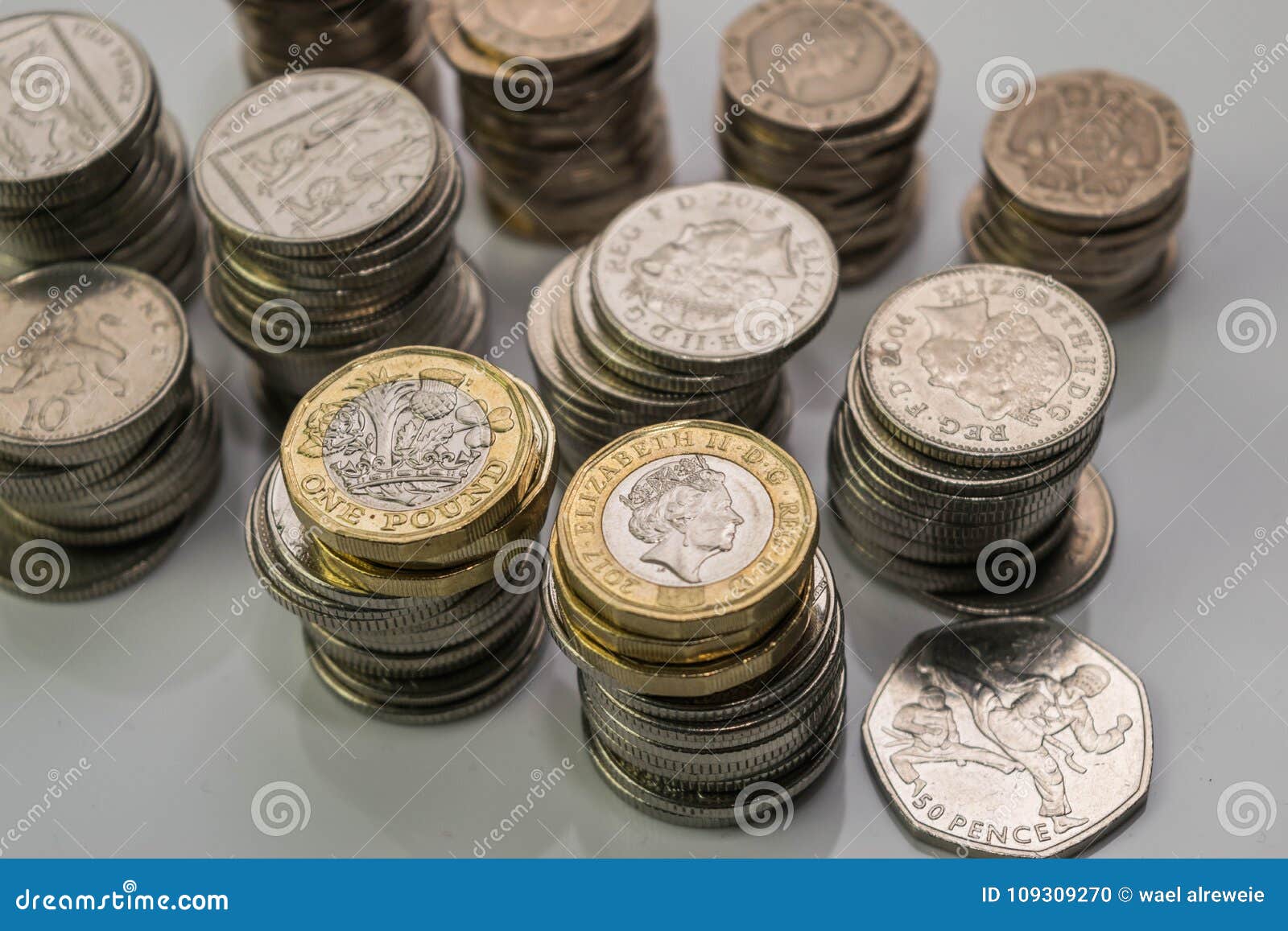 Stacks of Different British Coins on a White Background. Editorial ...