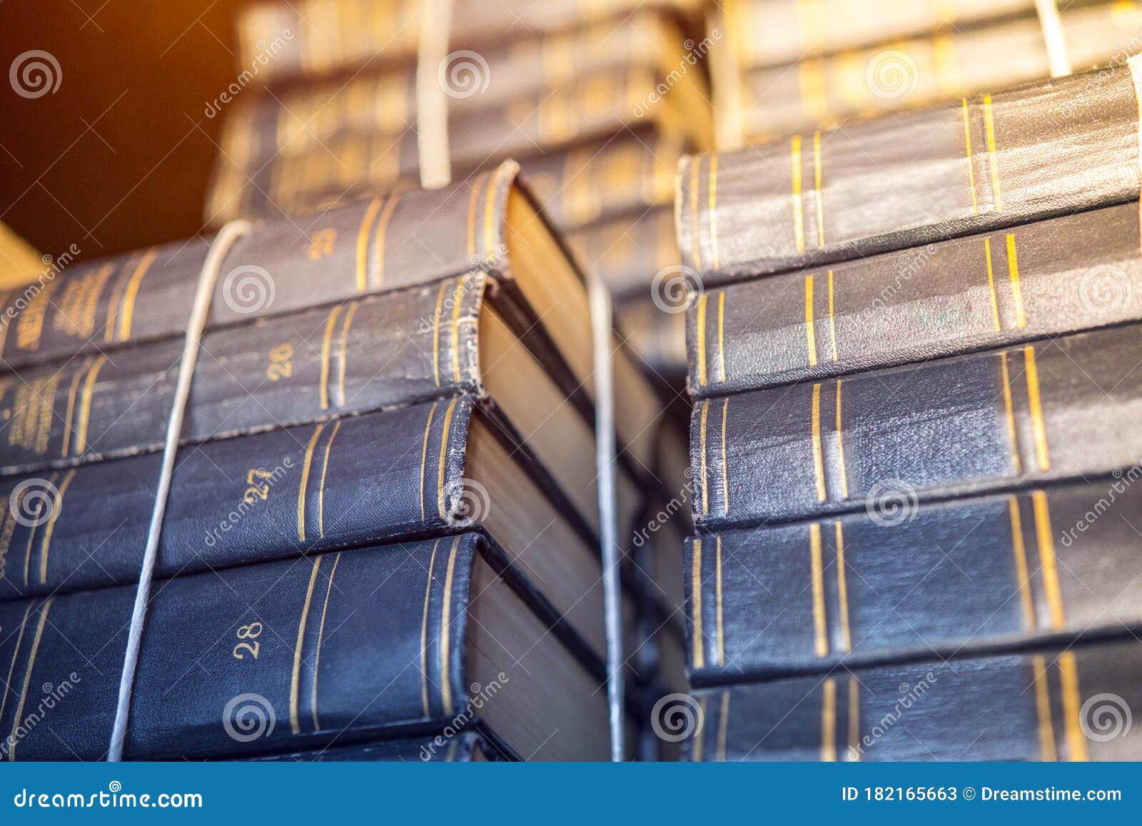 Stacks of Multi-volume Books with Dark Blue Covers, Blurred Background ...