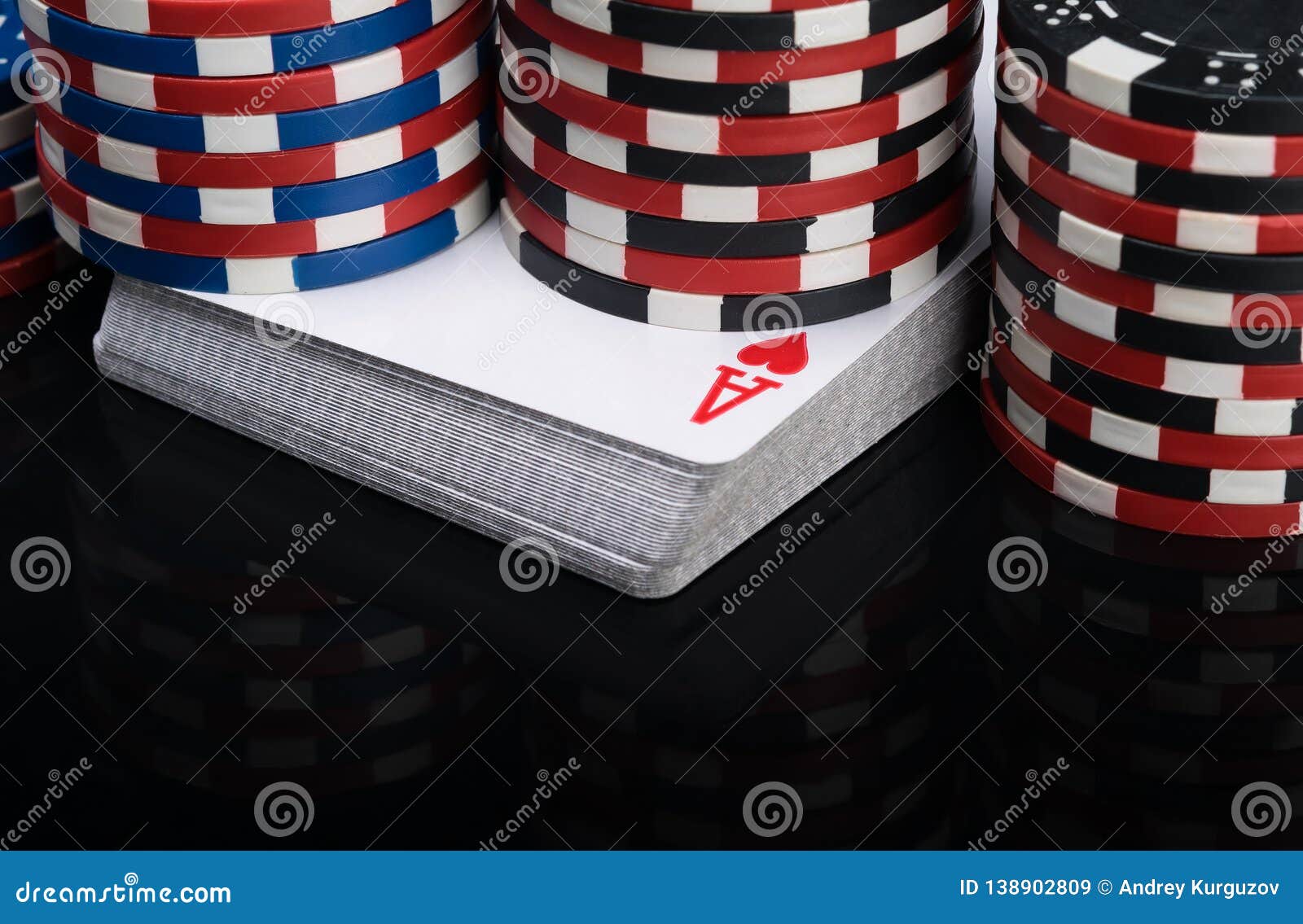 Stacks of Poker Chips Stand on a Deck of Playing Cards and are ...
