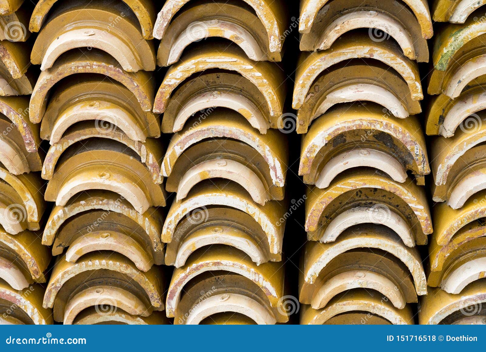 Stacks of Yellow Ceramic Glazed Curved Roof Tiles in a Symmetrical ...