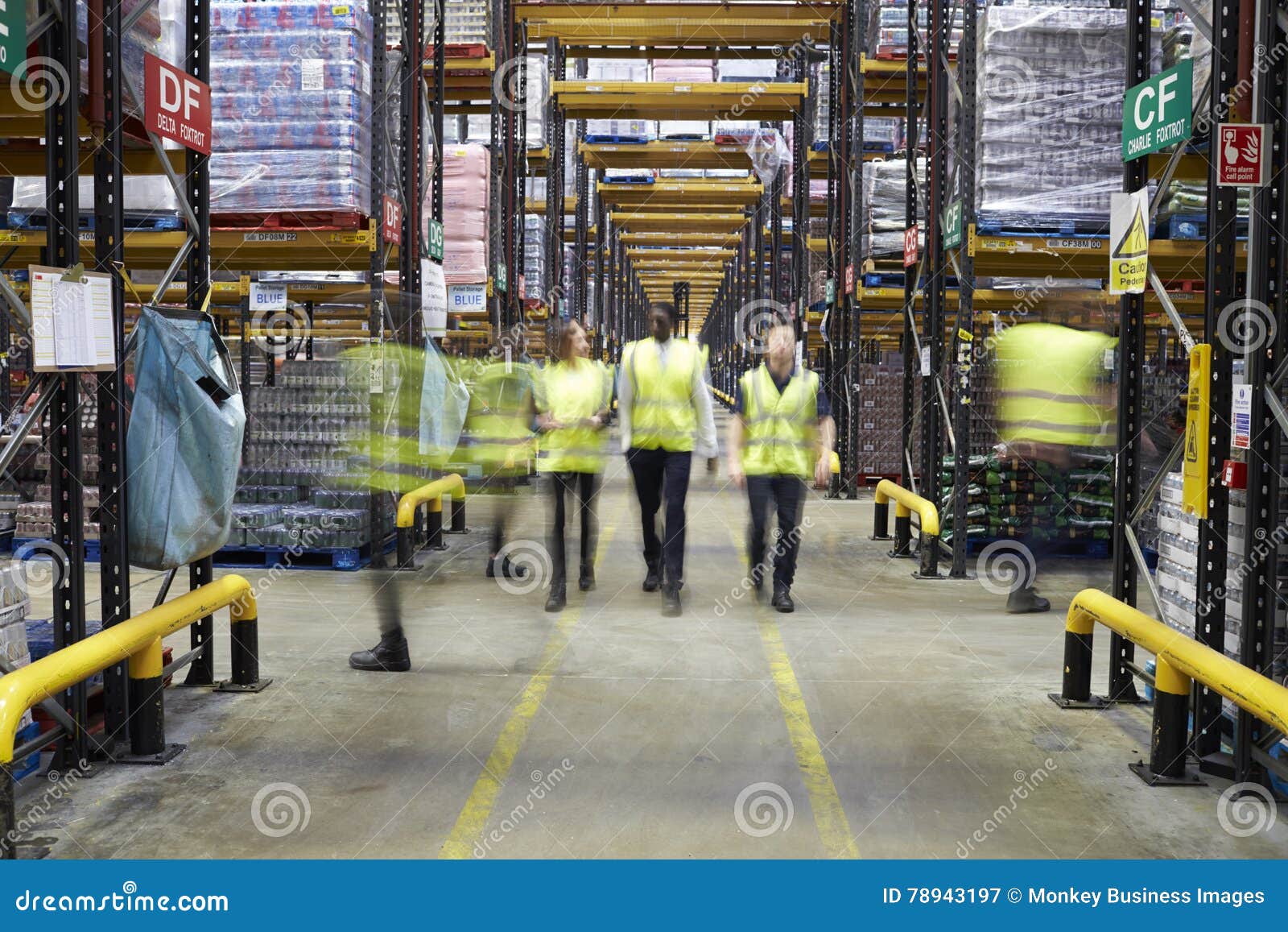 Staff in Reflective Vests Walking To Camera in a Warehouse Stock Image ...