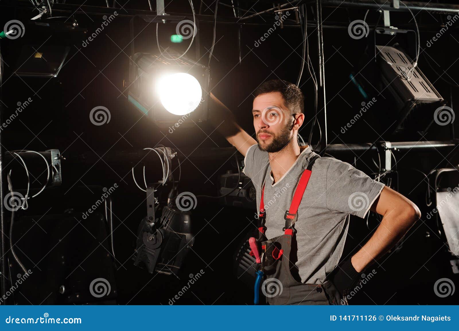 The Stage Worker Sets Up the Lights. the Lighting Engineer Adjusts the ...