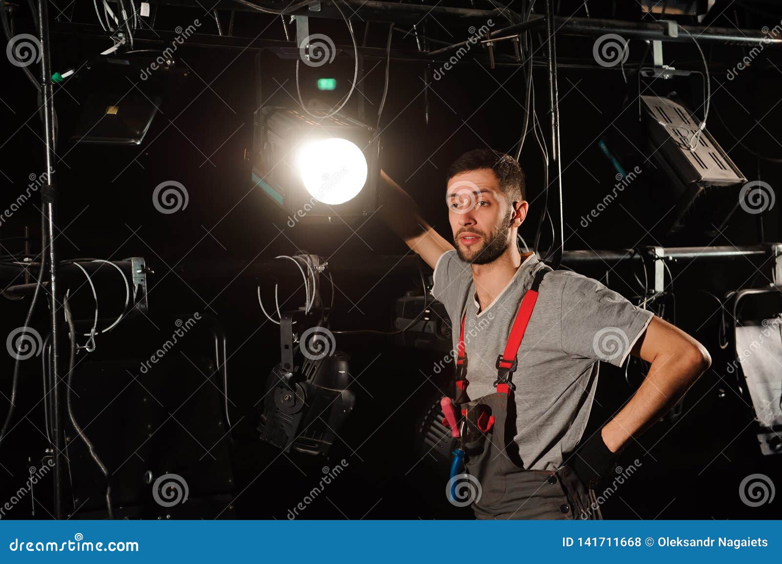 The Stage Worker Sets Up the Lights. the Lighting Engineer Adjusts the ...