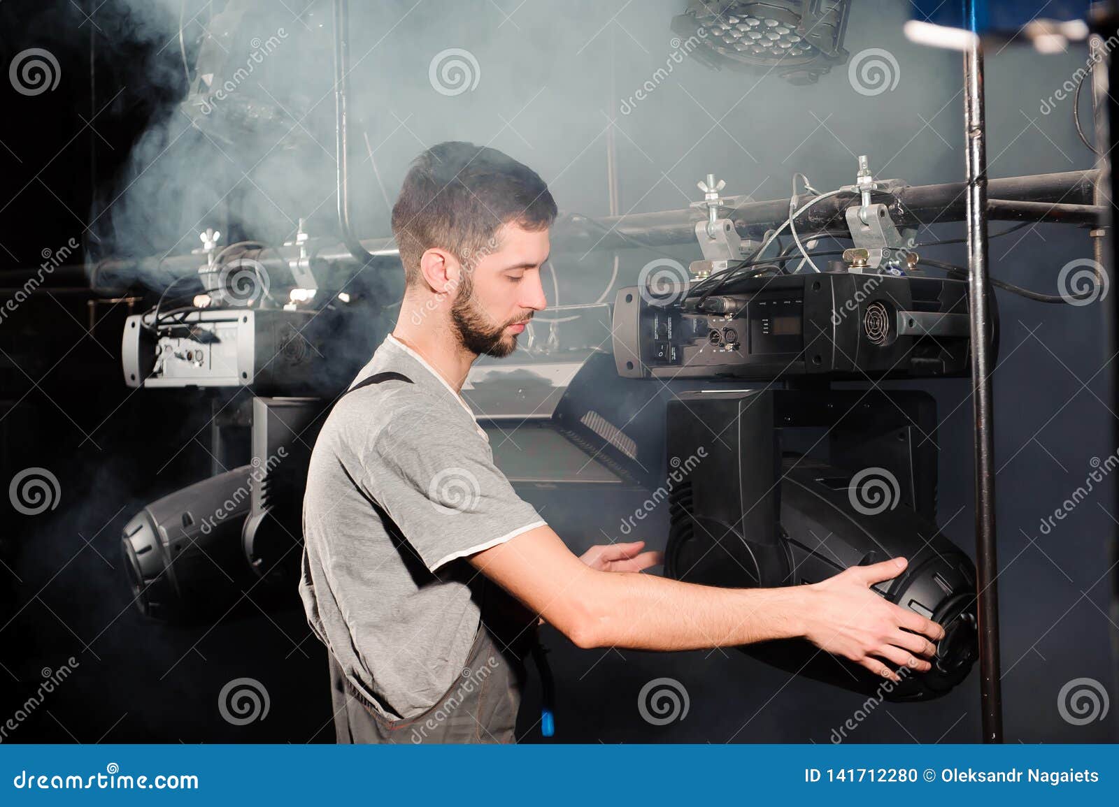 The Stage Worker Sets Up the Lights. the Lighting Engineer Adjusts the ...