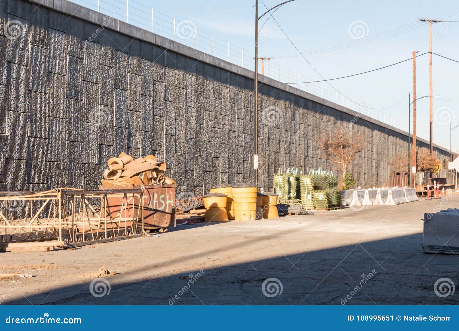 Staging Area of Road Construction Materials beside a Concrete Retaining ...