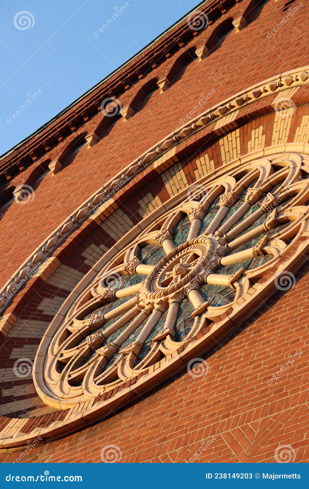 Stained Glass Round Window Surrounded by Red and Cream Brick Stock ...