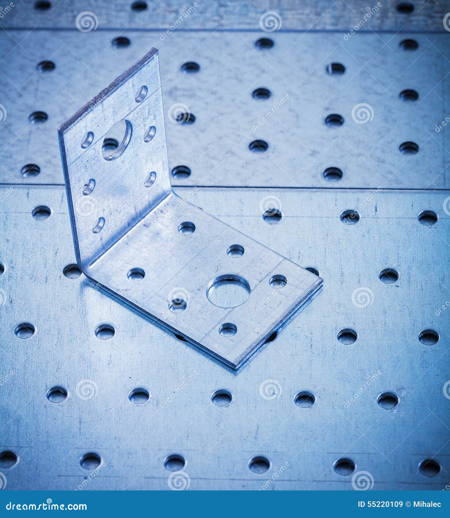 Stainless Angle Iron on Perforated Metallic Sheet Stock Image - Image ...