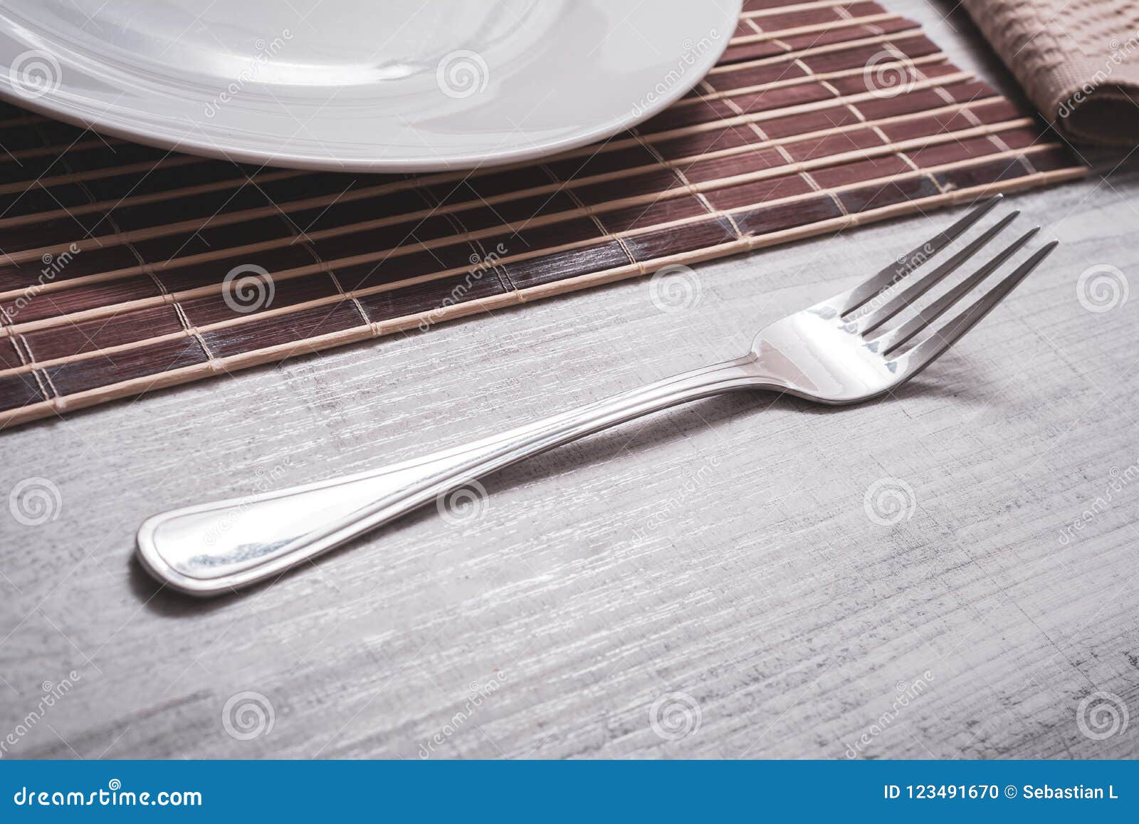 Stainless Steel Fork on a Table beside a Dinner Plate on Tablecloth ...