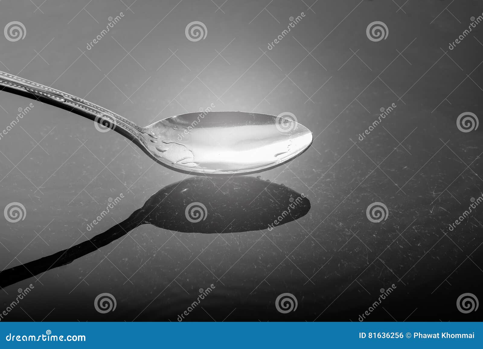 Stainless steel spoon stock photo. Image of drop, dark - 81636256