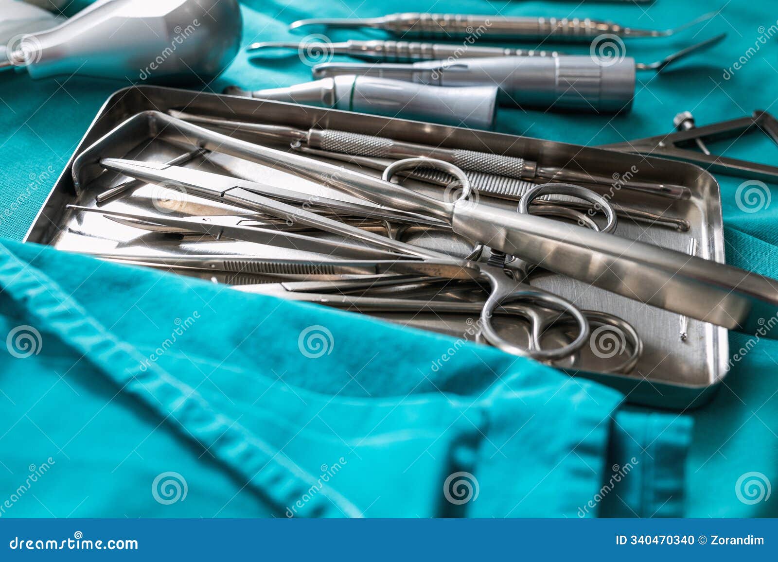 Stainless Steel Surgical Tools on a Teal Fabric Background Stock Photo ...
