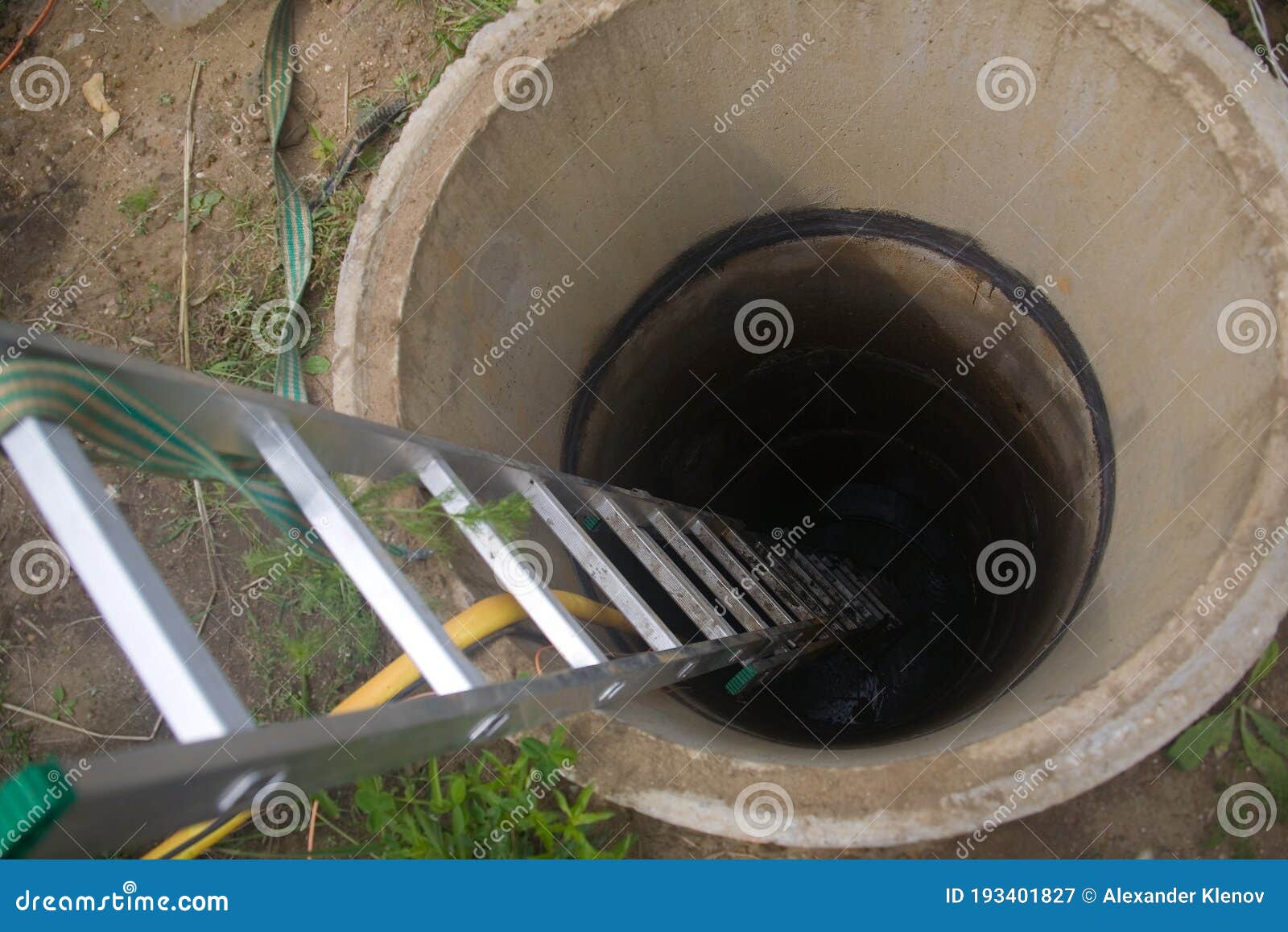 The Staircase is Lowered into a Deep Well Made of Concrete Rings Stock ...