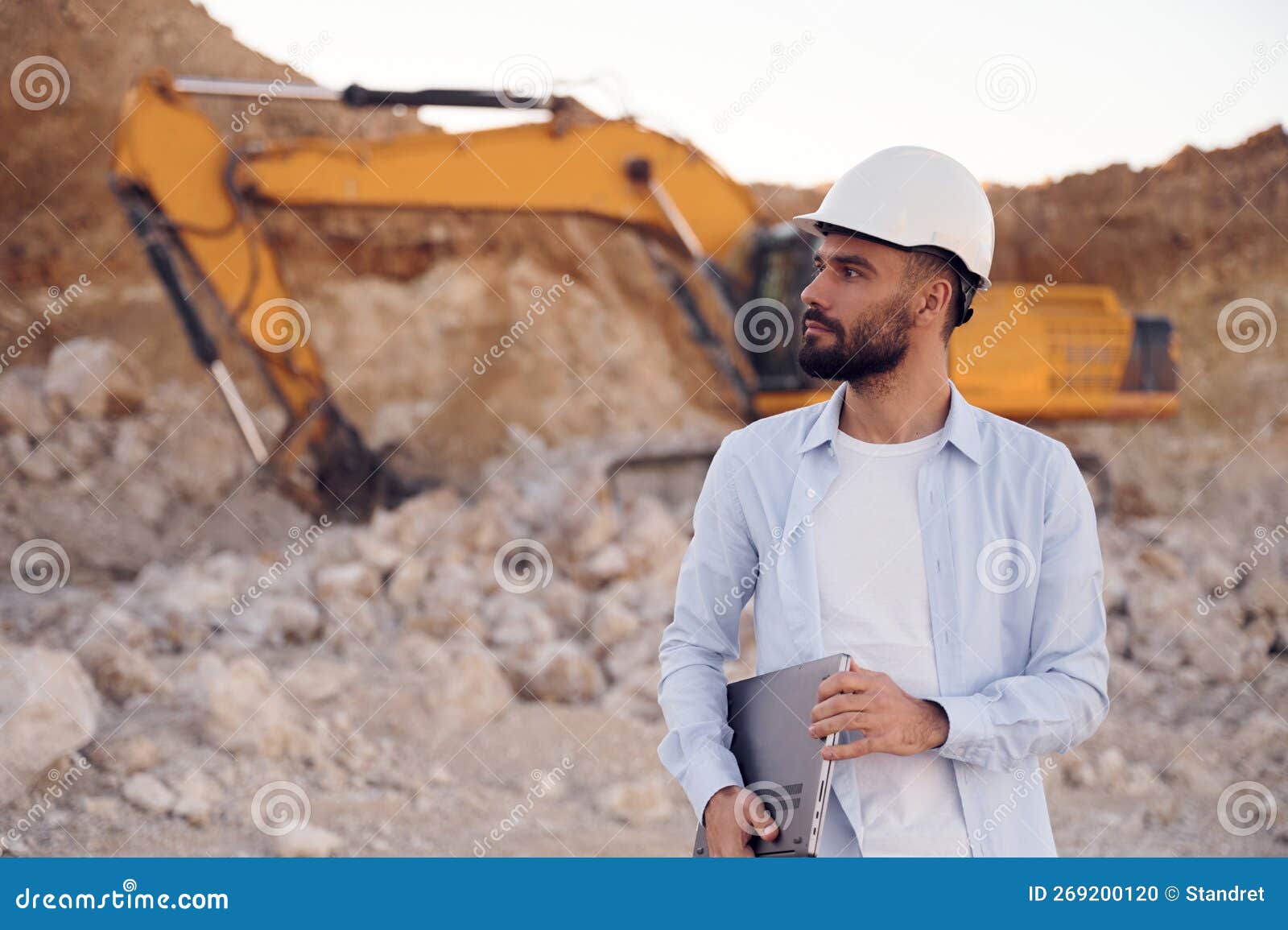 Standing Against Excavator. Man in Uniform is Working in the Quarry at ...