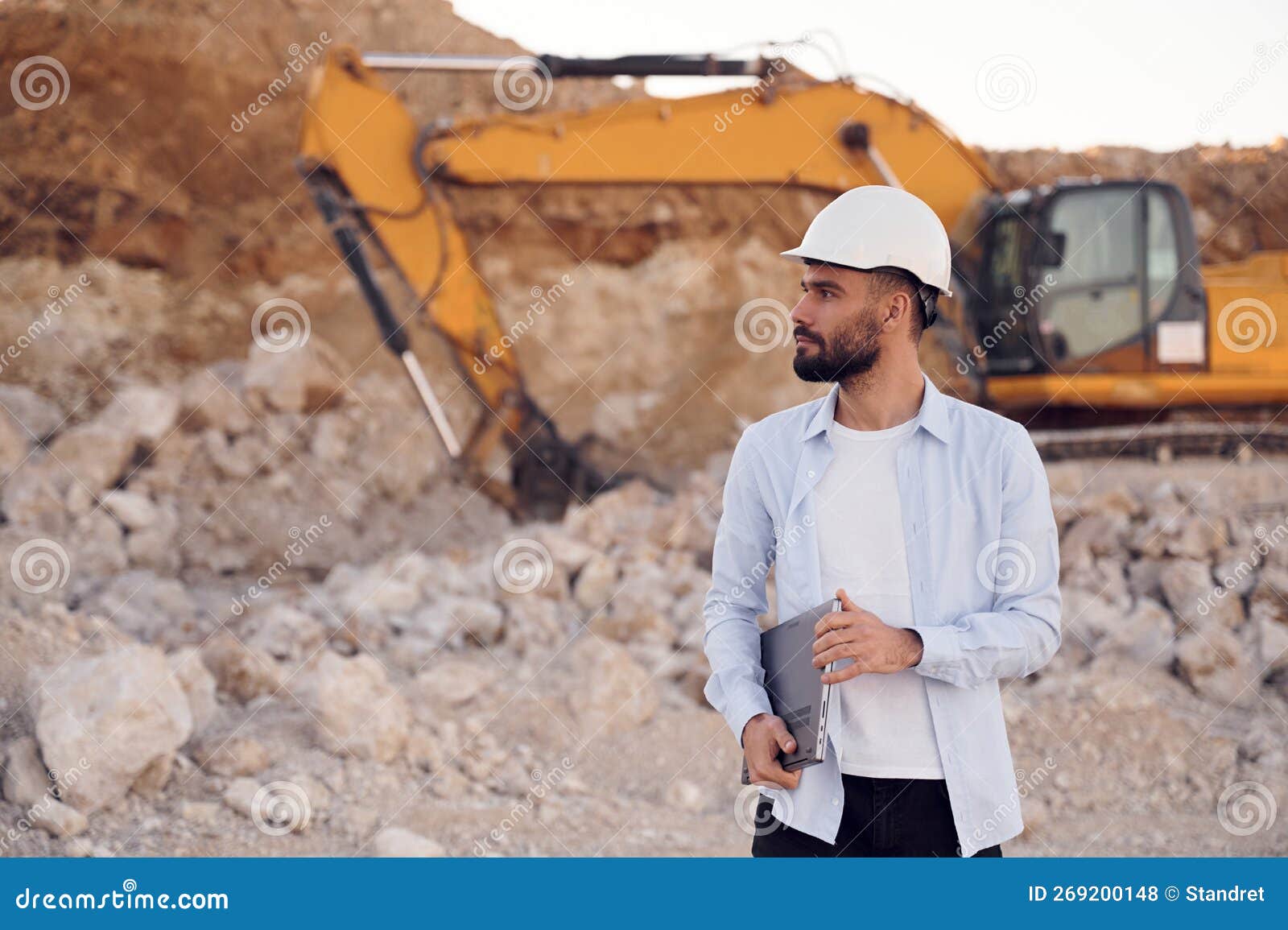 Standing Against Excavator. Man in Uniform is Working in the Quarry at ...