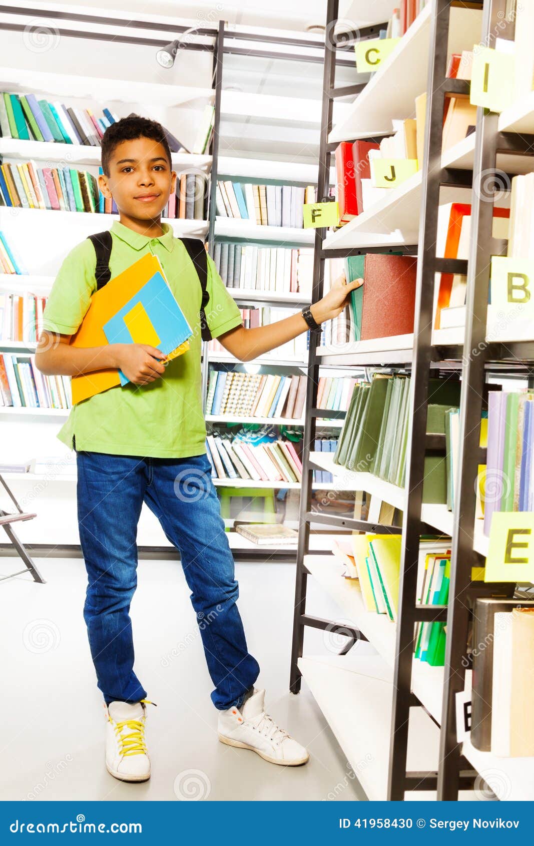 Standing Boy with Books in School Library Stock Photo - Image of ...