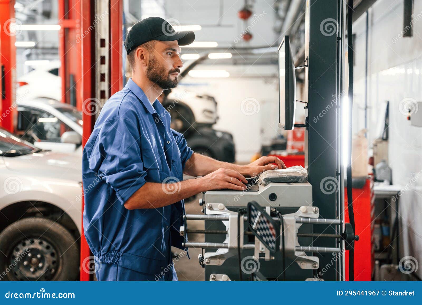 Standing by Computer Terminal. Auto Mechanic Working in Garage Stock ...