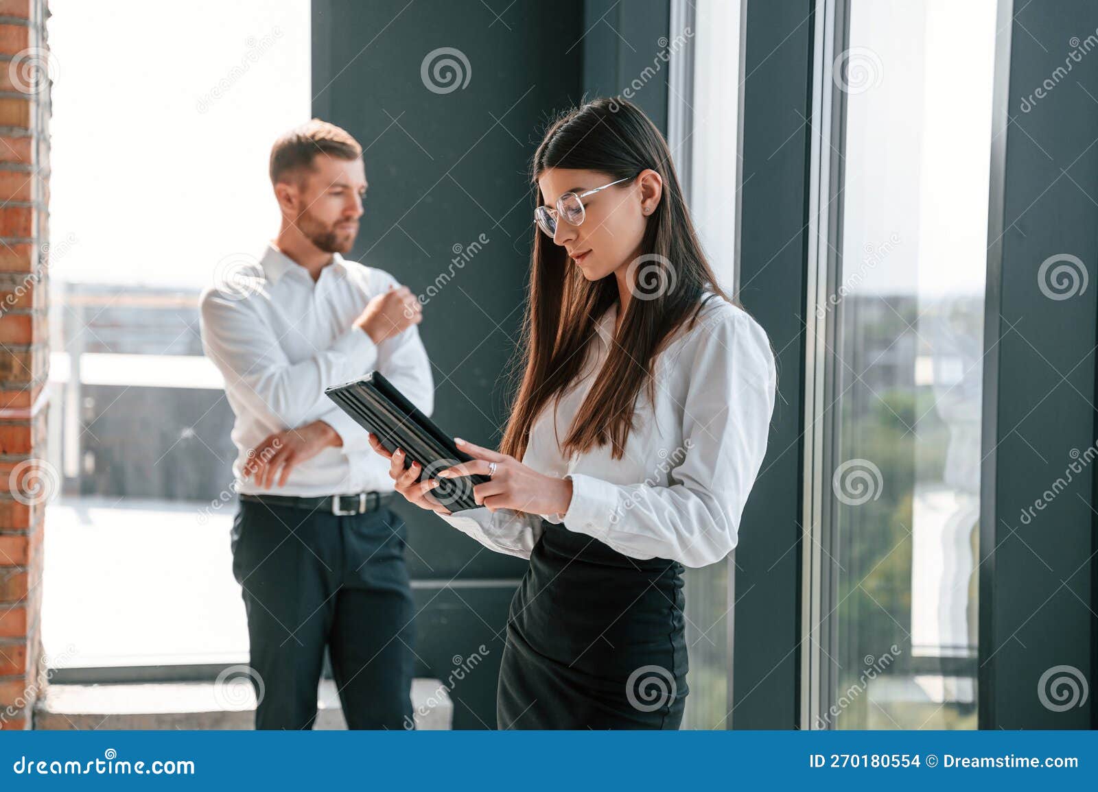 Standing with Documents in Hands. Industry Workers are in the Building ...