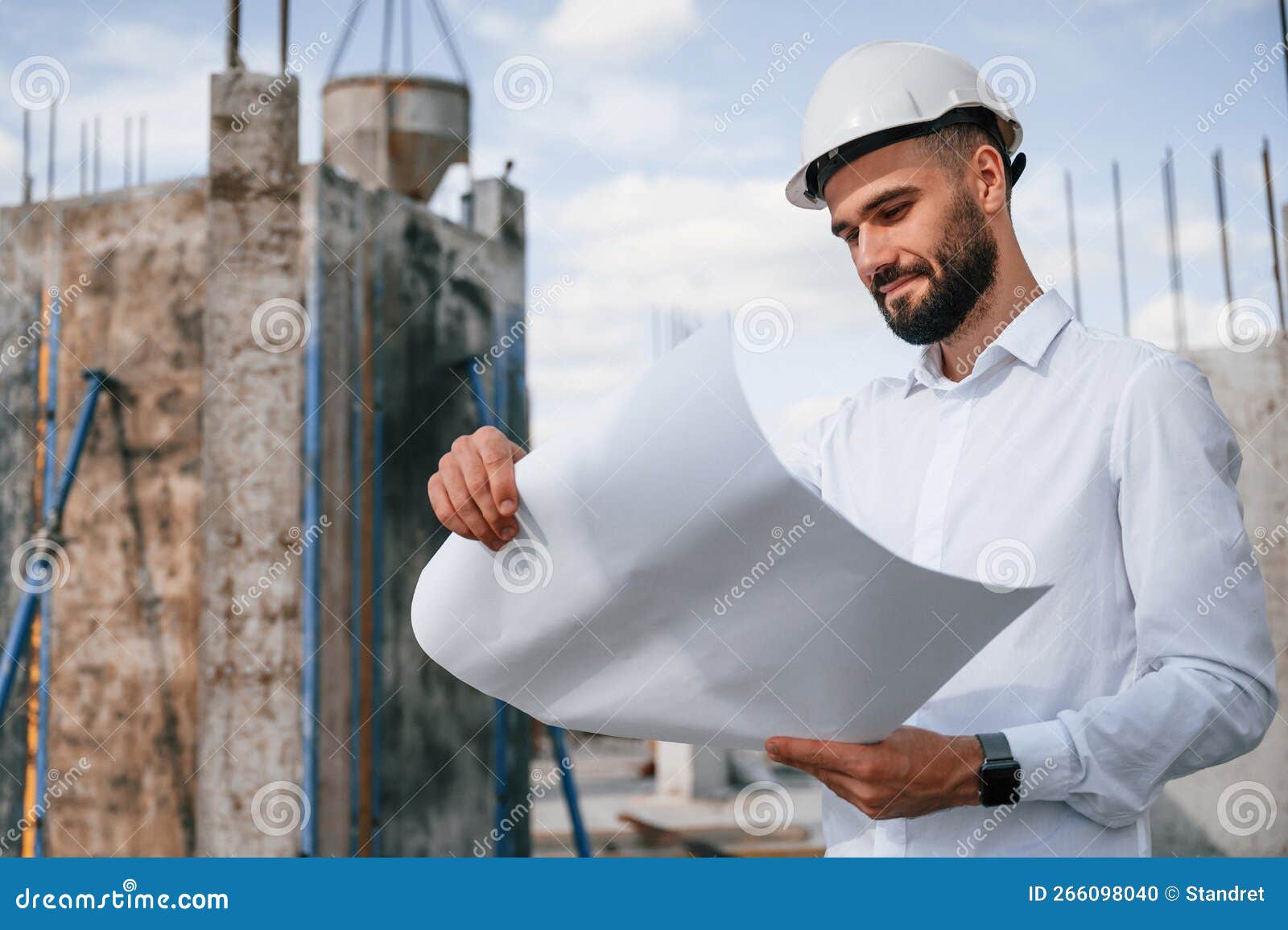 Standing and Holding Plan in Hands. Man in Uniform is Working on the ...