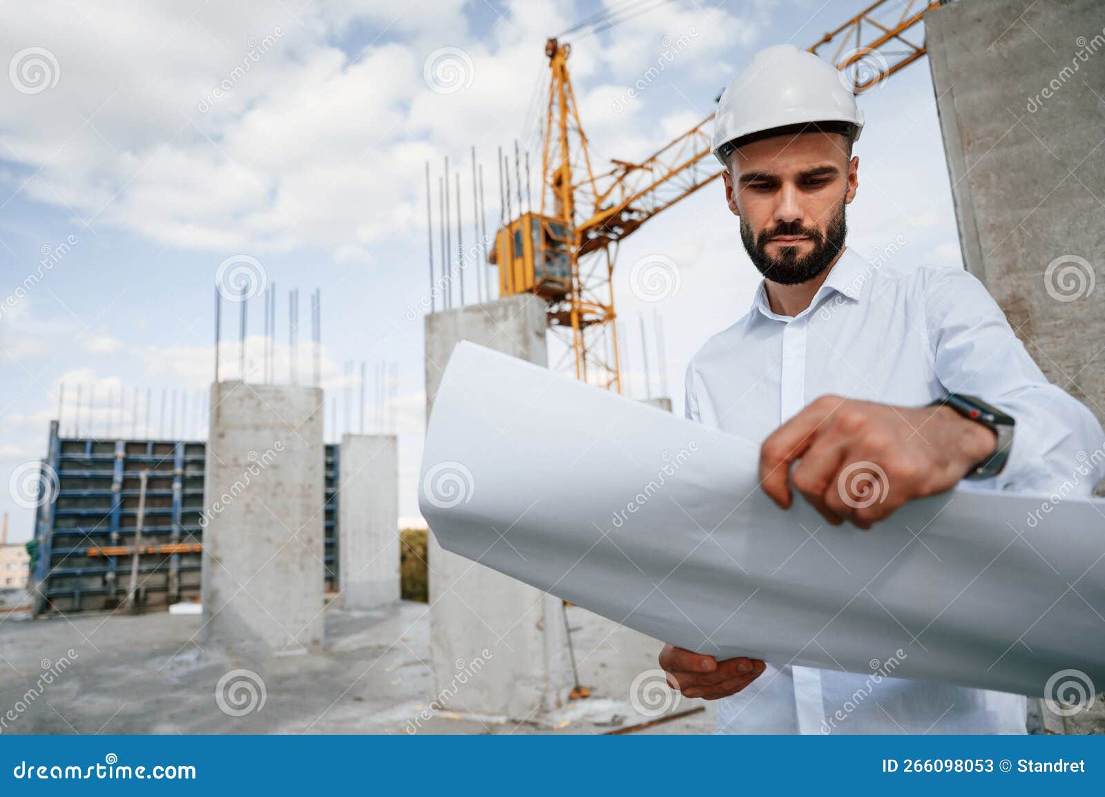 Standing and Holding Plan in Hands. Man in Uniform is Working on the ...