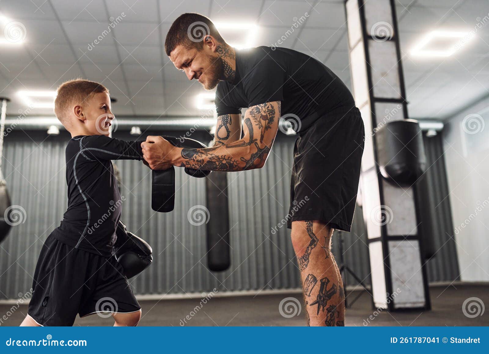 Standing and Learning How To Punch. Coach is Teaching the Boy Box ...