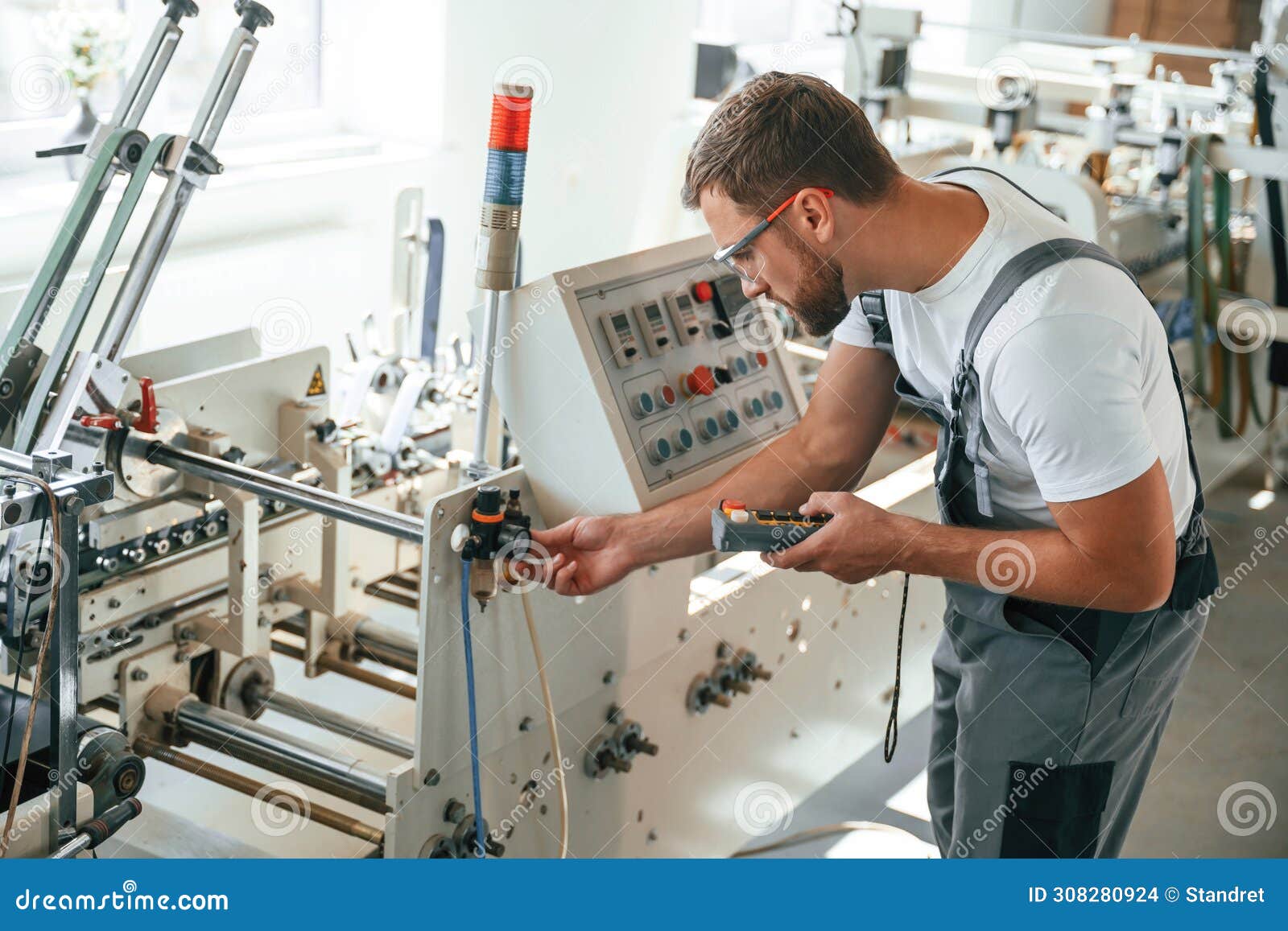 Standing by the Machine. Handsome Man is Working at the Factory of Creating Eco Boxes Stock ...
