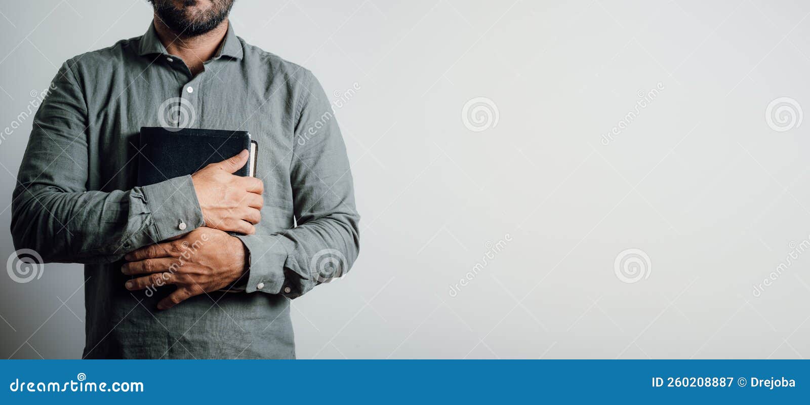 Standing Man Holding and Hugging the Bible on His Chest Stock Image ...