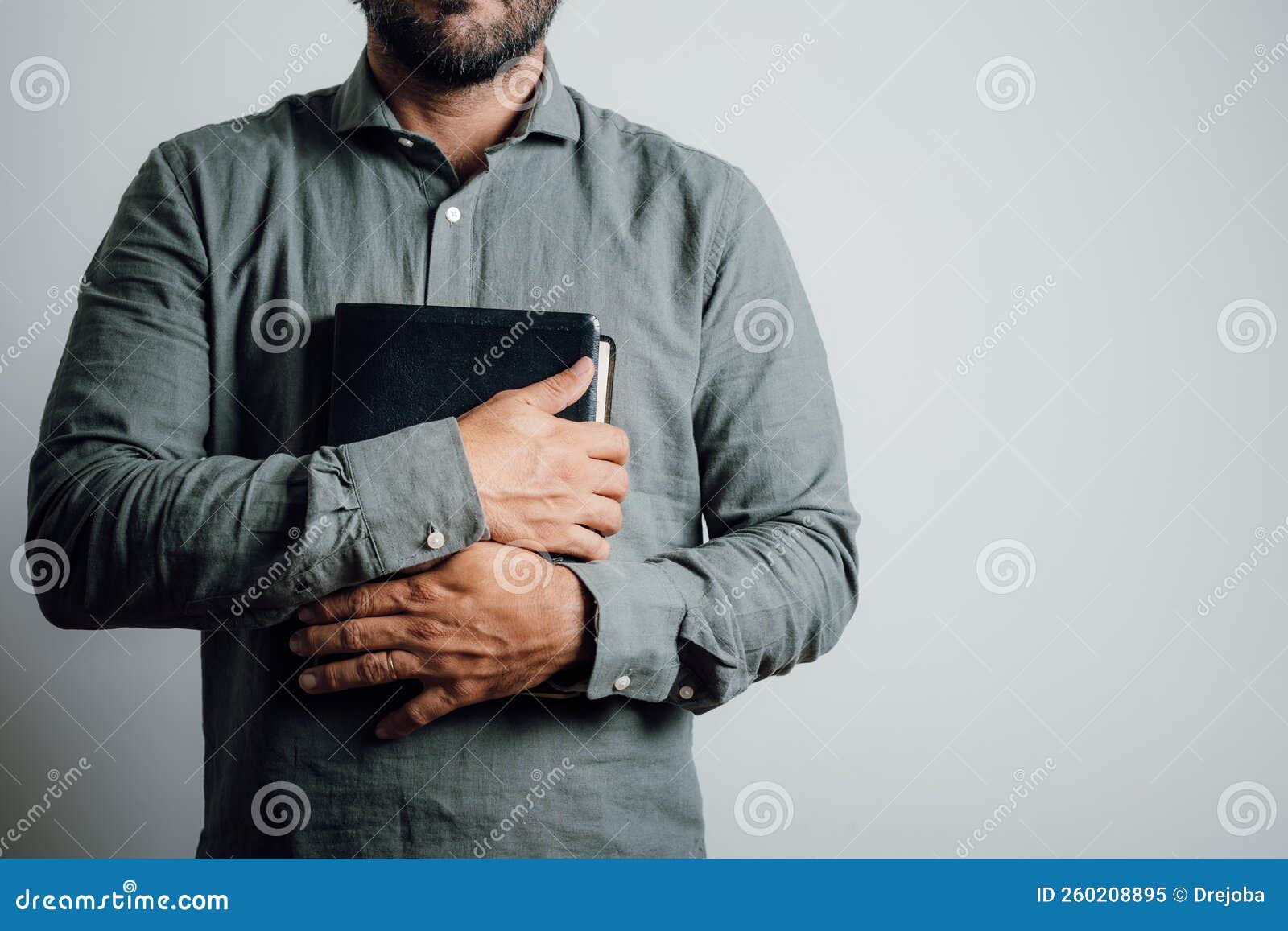 Standing Man Holding and Hugging the Bible on His Chest Stock Image ...