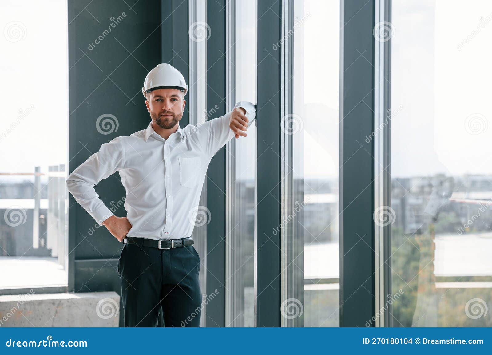 Standing Near Panoramic Windows. Man in White Shirt is Working Indoors ...