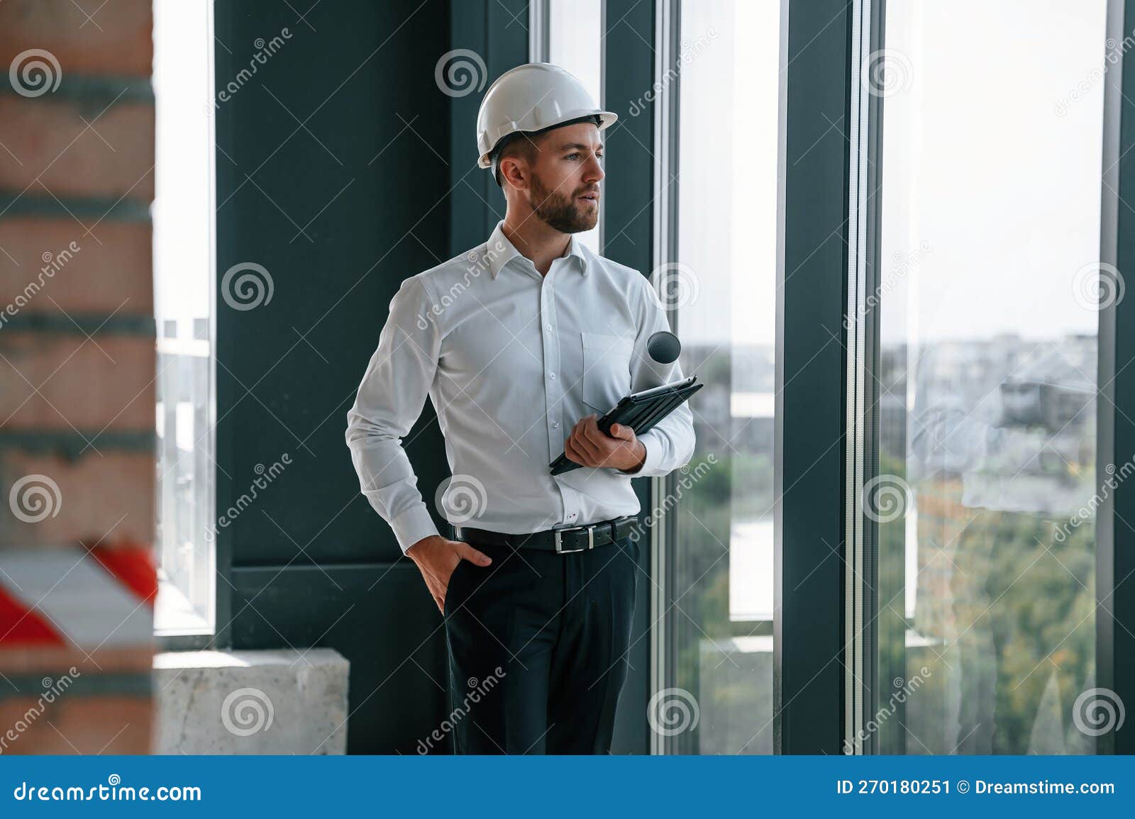 Standing Near Panoramic Windows. Man in White Shirt is Working Indoors ...