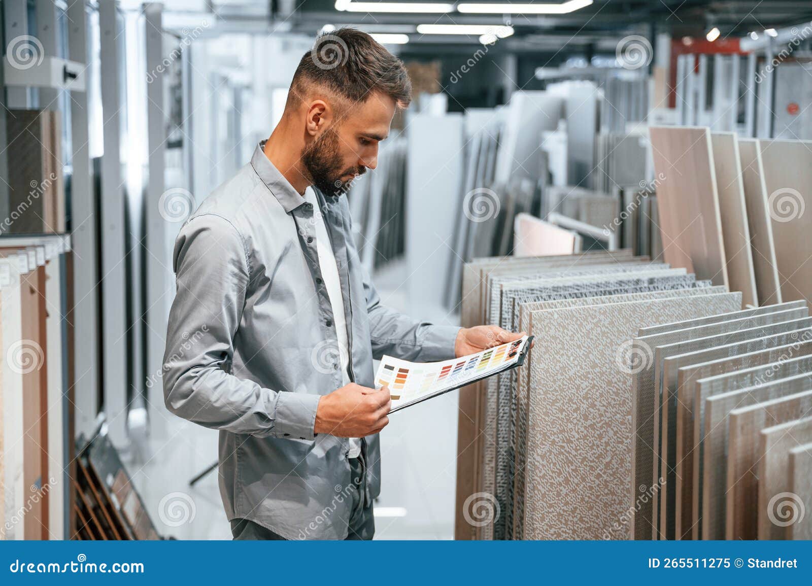 Standing with Notepad in Hands. Stylish Beautiul Man is in the Store of ...