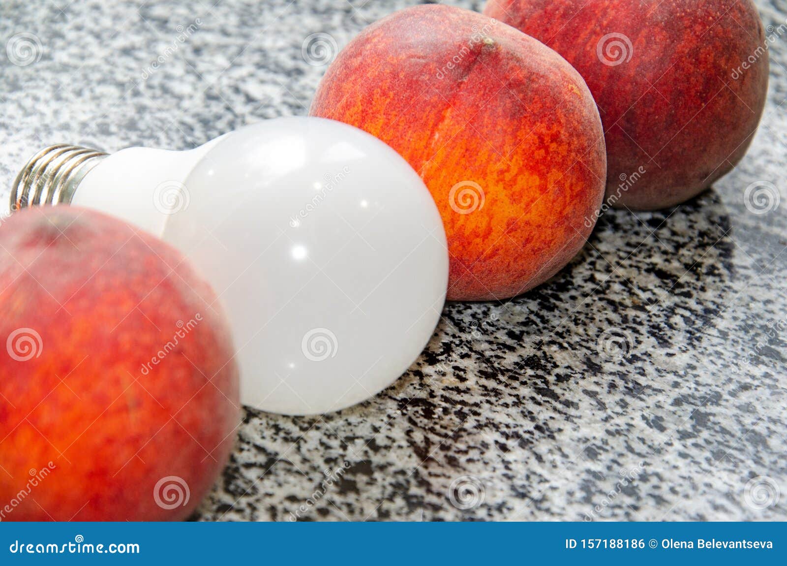 Standing Out Light Bulb in a Row of Identical Ripe Peaches, the Concept ...