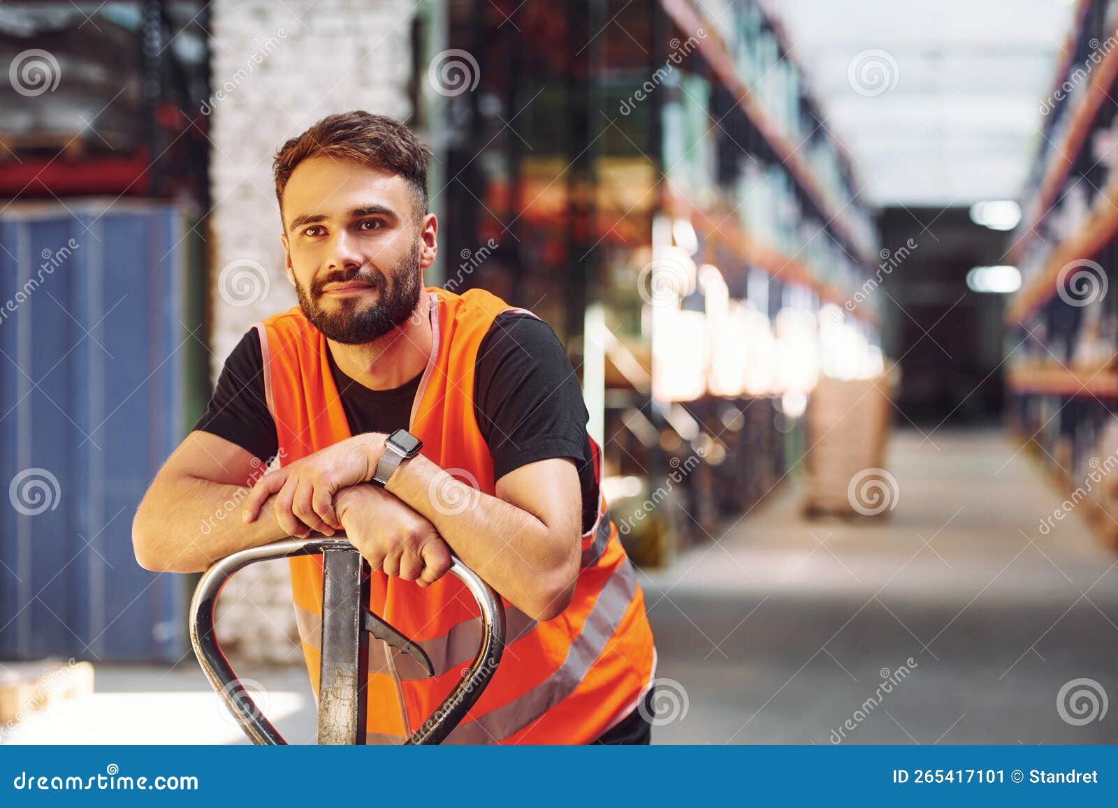 Standing with Platform Trolley. Storage Worker is in the Warehouse with ...